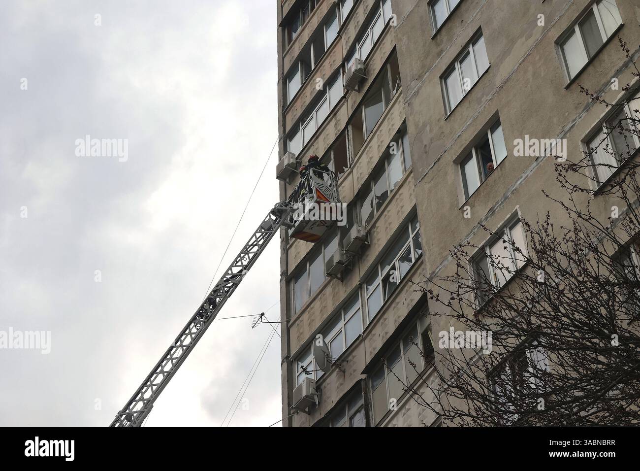 Rescuers use an aerial ladder platform at a 16-storey apartment block ...