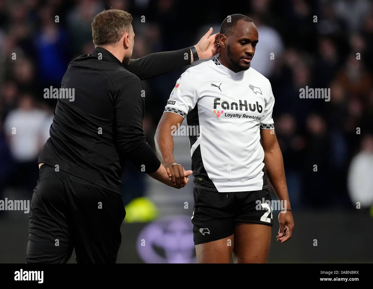 Derby County's Ryan Nyambe (right) is consoled by manager John Eustace ...