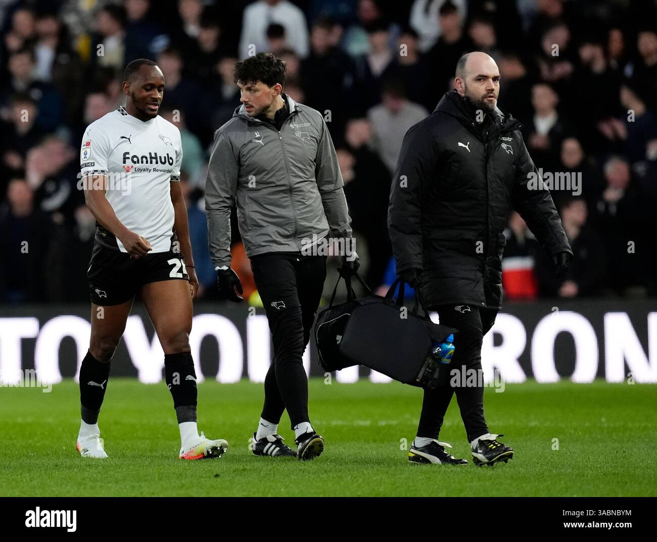 Derby County's Ryan Nyambe (left) leaves the pitch with an injury ...