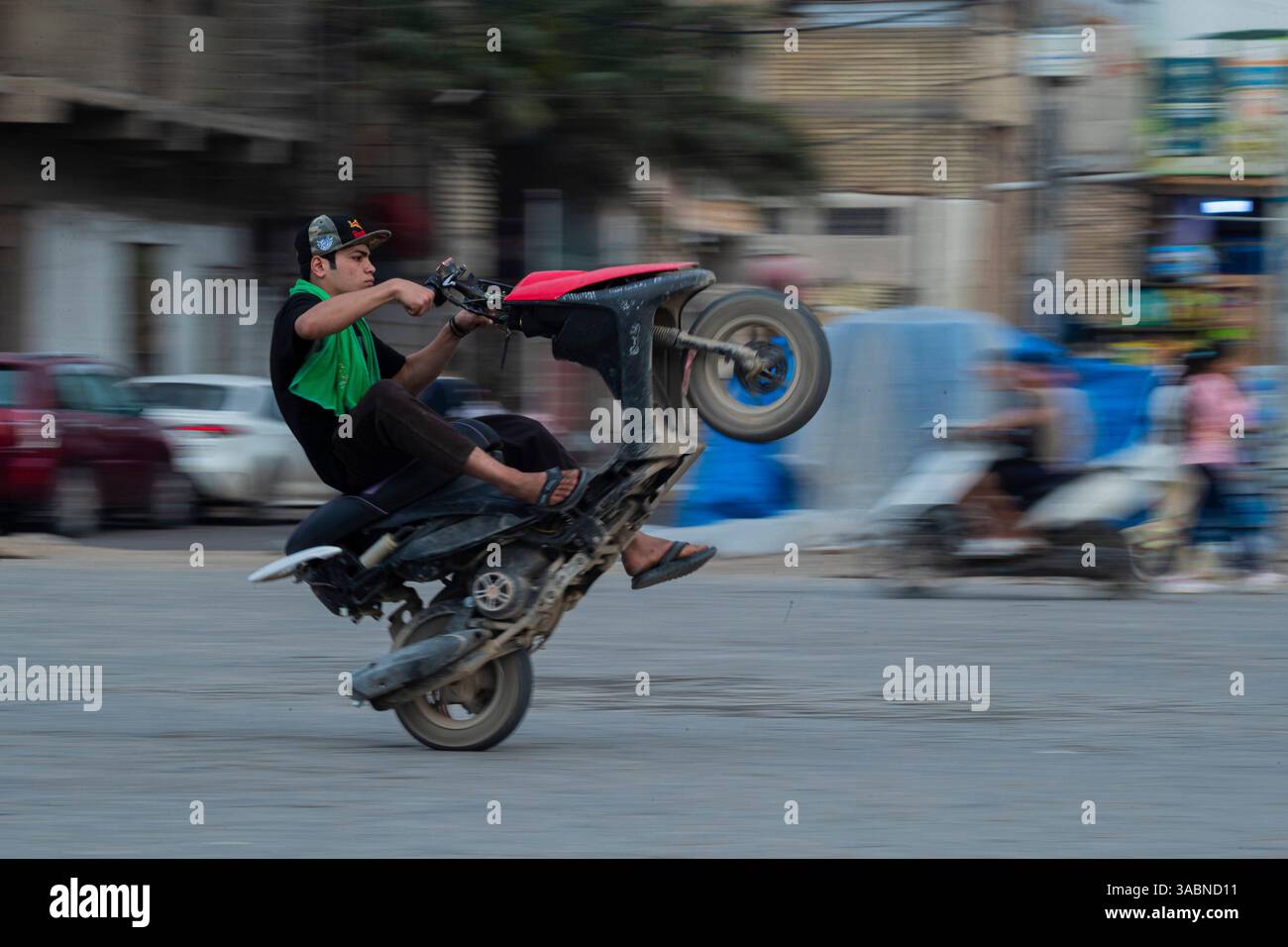 A man rides his motorcycle during Eid al-Fitr celebrations marking the ...