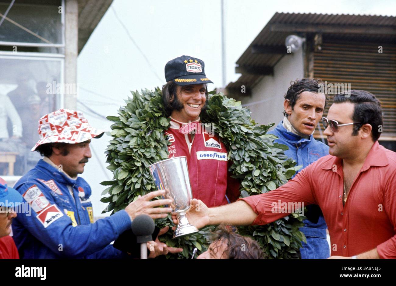 The podium (L to R): Clay Regazzoni (SUI) Ferrari second; Emerson ...