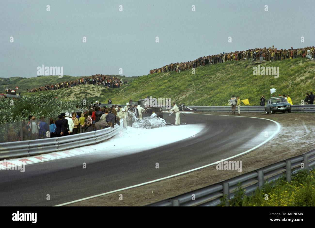 The overturned and gutted March 731 of Roger Williamson (GBR) is dealt ...