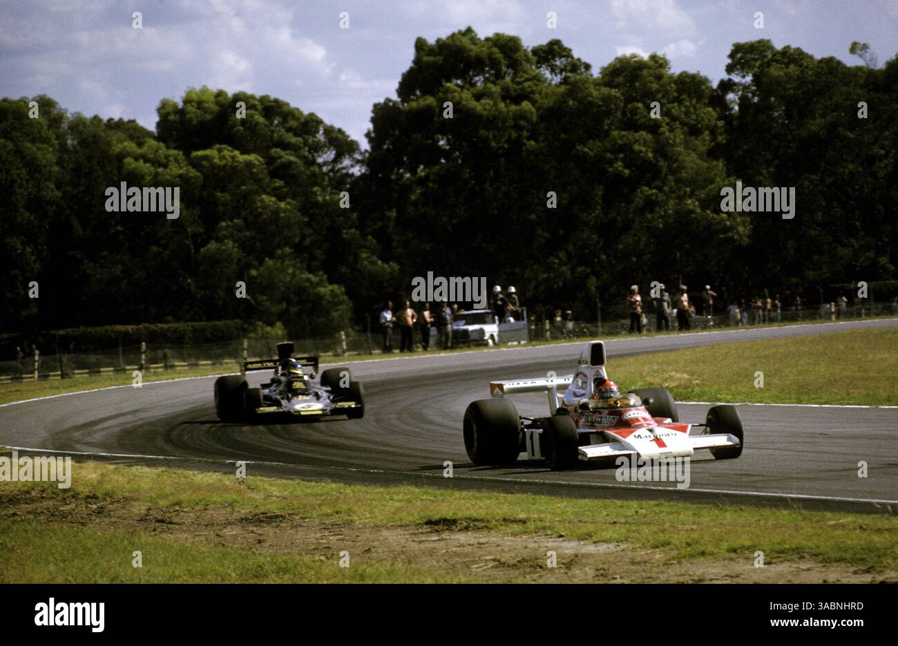 Race winner Emerson Fittipaldi (BRA) McLaren M23 leads Ronnie Peterson ...