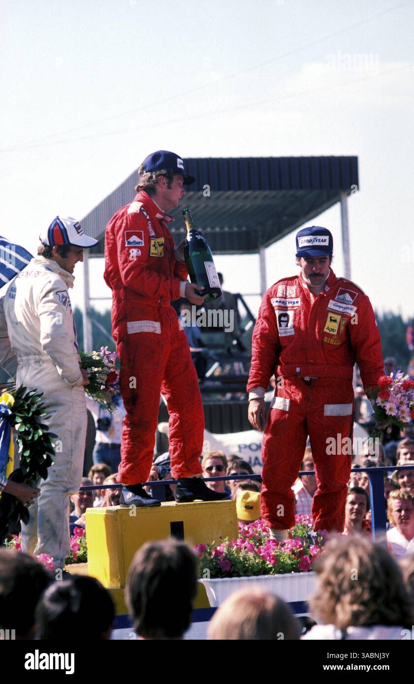 The podium (L to R): Carlos Reutemann (ARG) Brabham, second; Niki Lauda ...