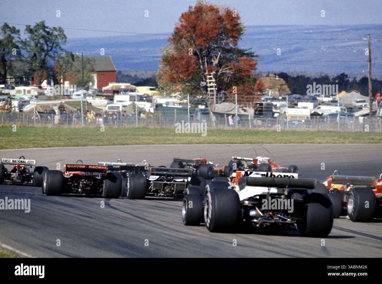 The cars dive into the 90-degree turn one at the start of the race ...