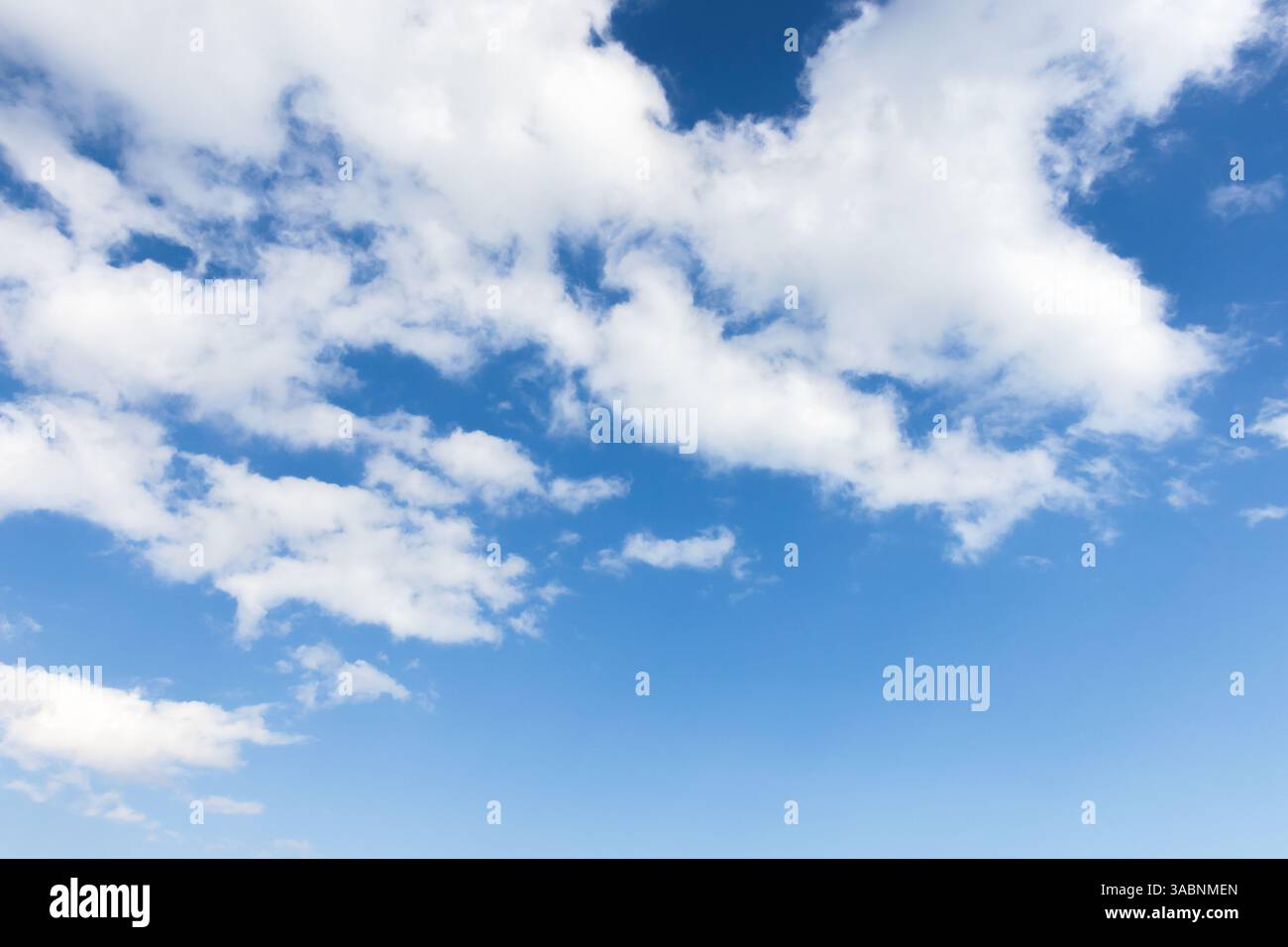 Beautiful clear blue sky with soft white clouds spread out, creating a ...