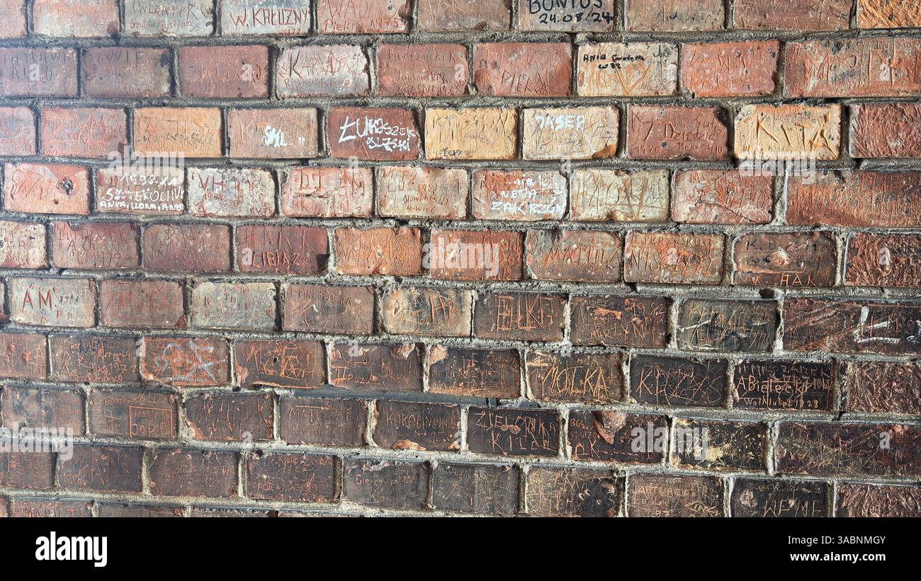 Close-up of a weathered brick wall with deep scratches and signs of age ...