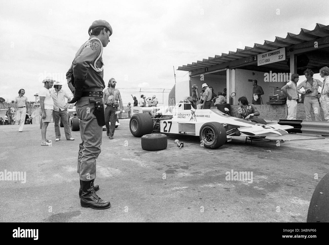 A soldier in the pits takes a look at the Hill Lola T370 of Guy Edwards (GBR), who retired from ...
