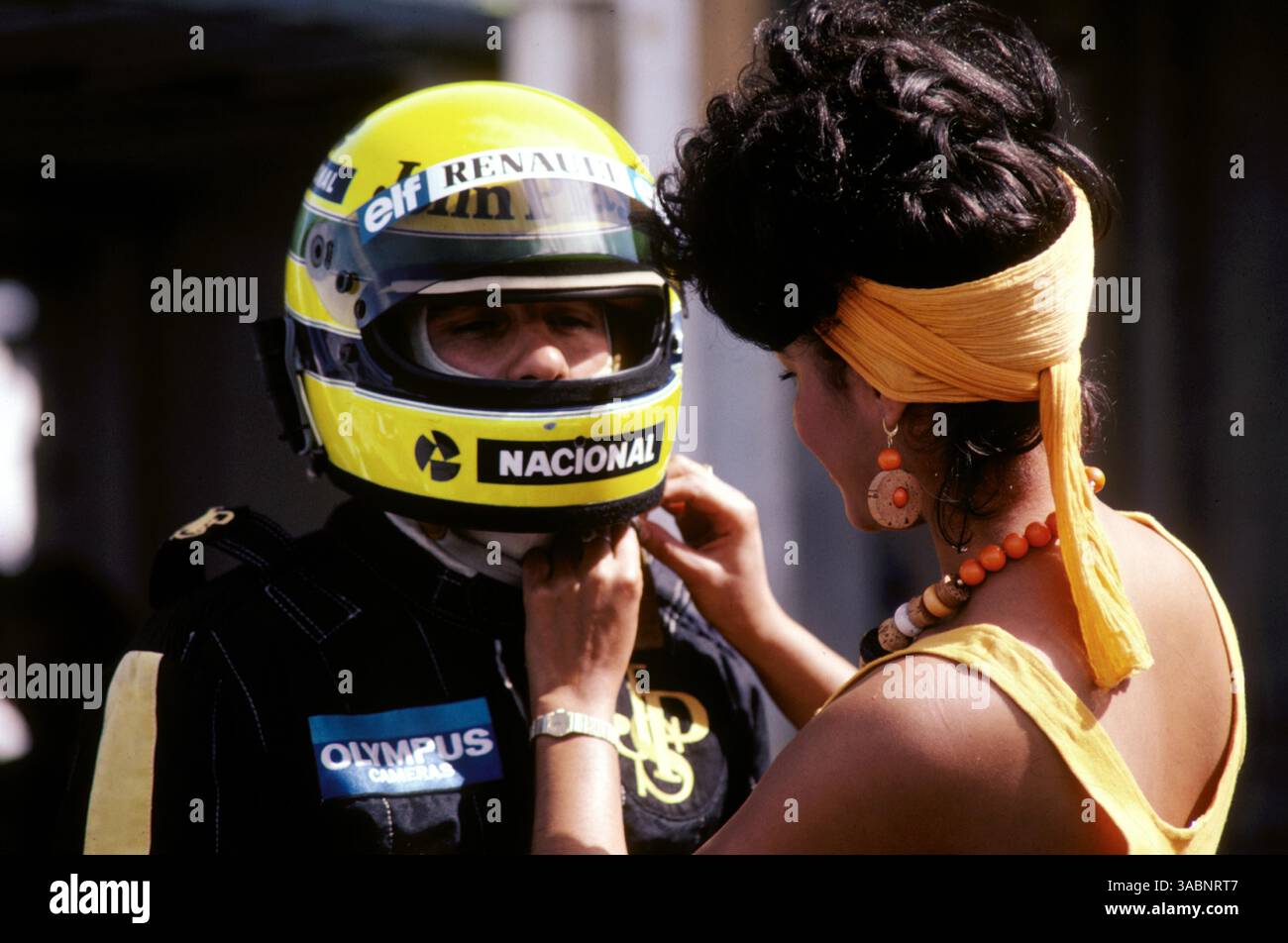 Second place finisher Ayrton Senna (BRA) Lotus has his helmet tightened ...