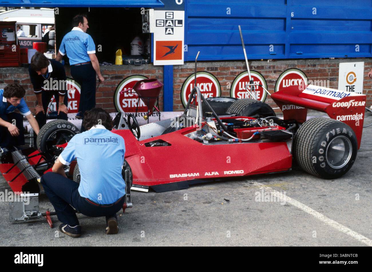Mechanics work on the radical new Brabham BT46, which featured angled ...