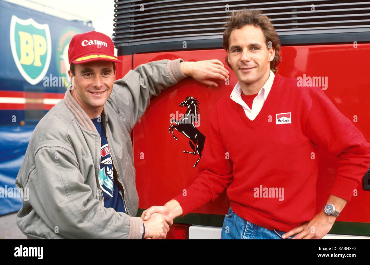 Gerhard Berger (AUT) greets his new 1989 team mate Nigel Mansell (GBR ...