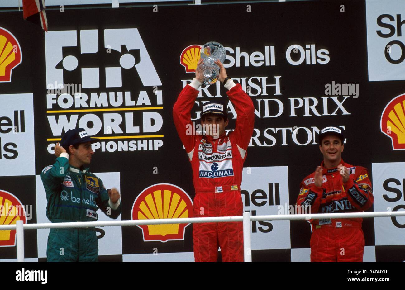 Race winner Ayrton Senna celebrates on the podium with Nigel Mansell ...