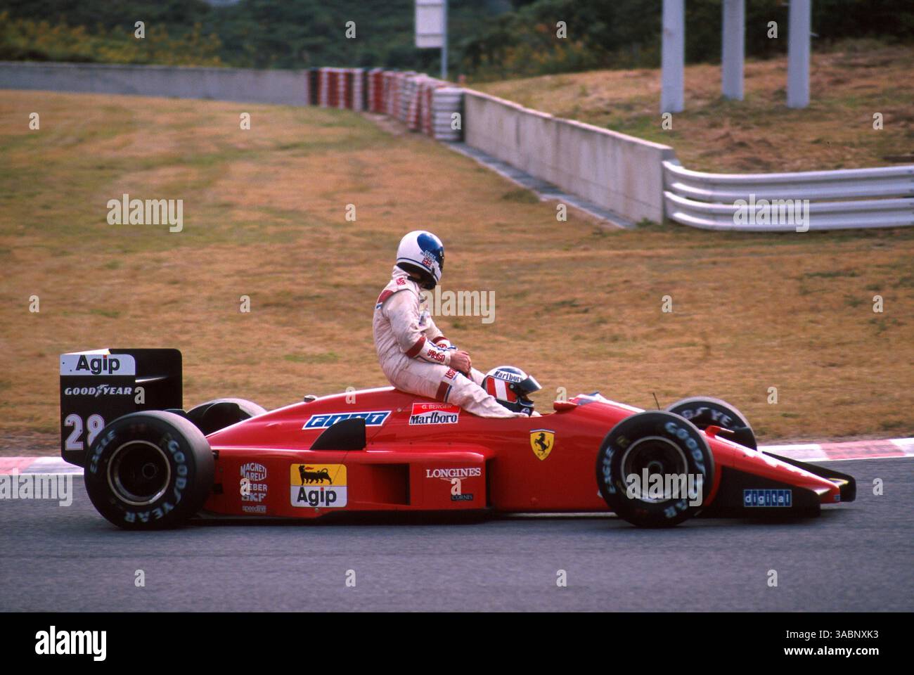 Gerhard Berger (AUT) Ferrari F1/87/88C 4th place, giving Derek Warwick ...
