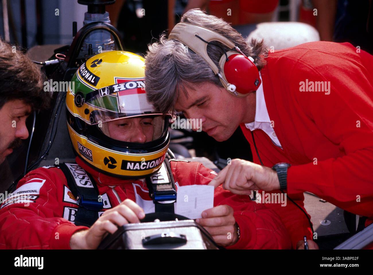 Ayrton Senna (BRA) McLaren MP4/4 discusses a telemetry printout with ...