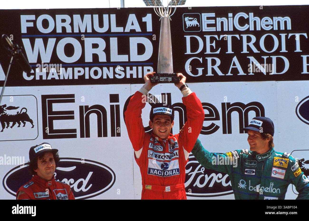 Race winner Ayrton Senna celebrates on the podium with Alain Prost ...