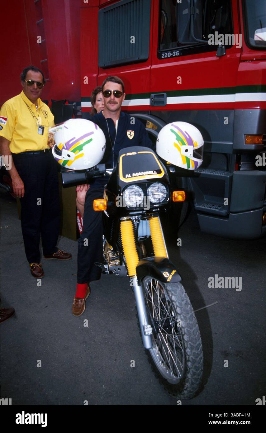 Cesare Fiorio, Ferrari Team manager watch as Nigel Mansell and his wife Rosanne arrive on a ...