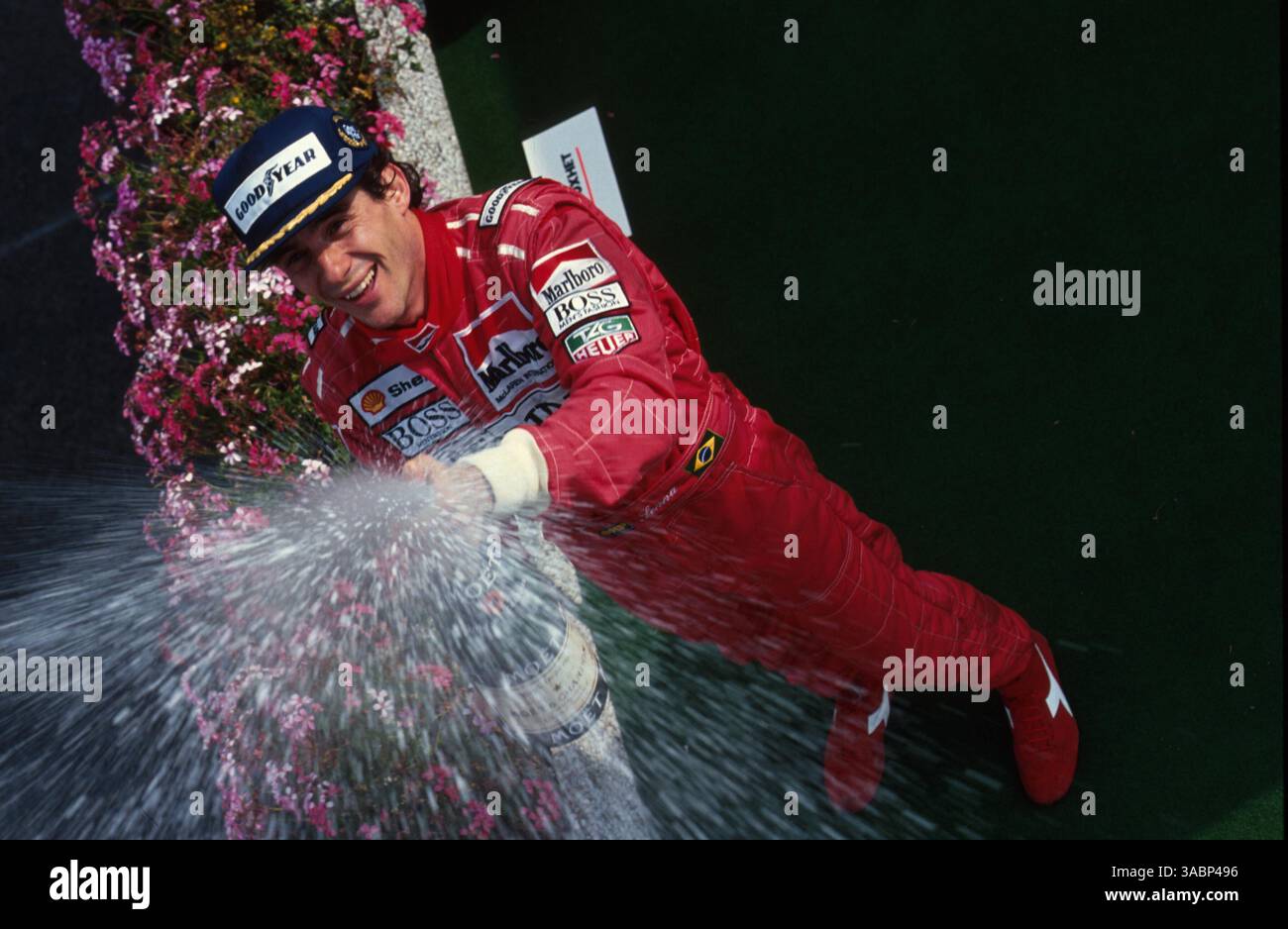 Race winner Ayrton Senna celebrates his victory on the podium...Belgian ...