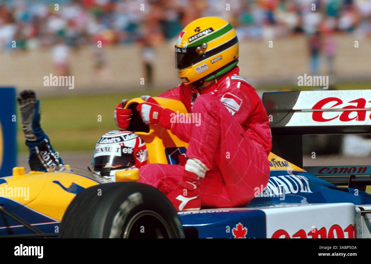 Race winner Nigel Mansell (GBR) Williams FW14 carries back to the pits fourth place finisher ...
