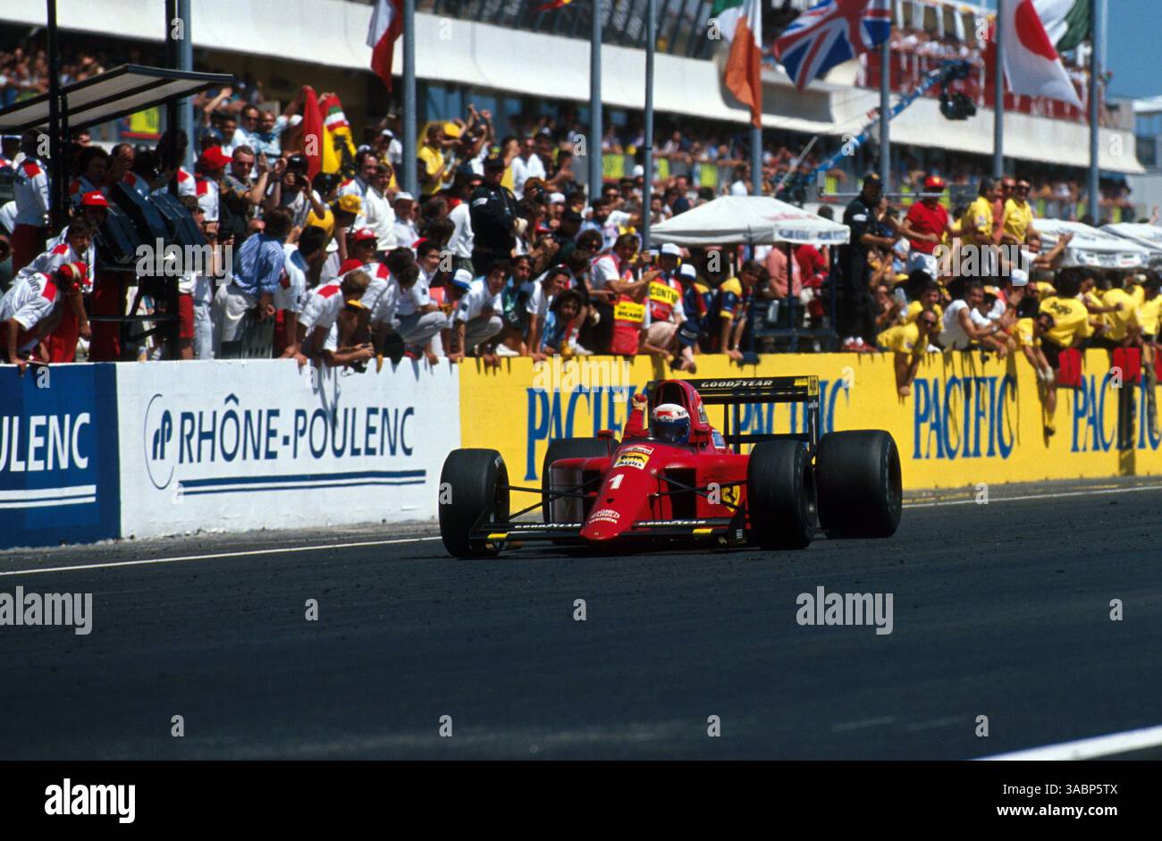 Alain Prost (FRA) Ferrari 641 crosses the line to score Ferrari's 100th Grand Prix victory ...