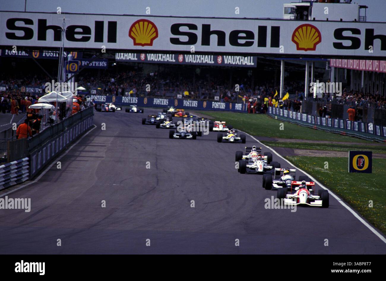 Laurent Aiello (FRA) Pacific Racing Reynard-Mugen 92D, leads a train of ...