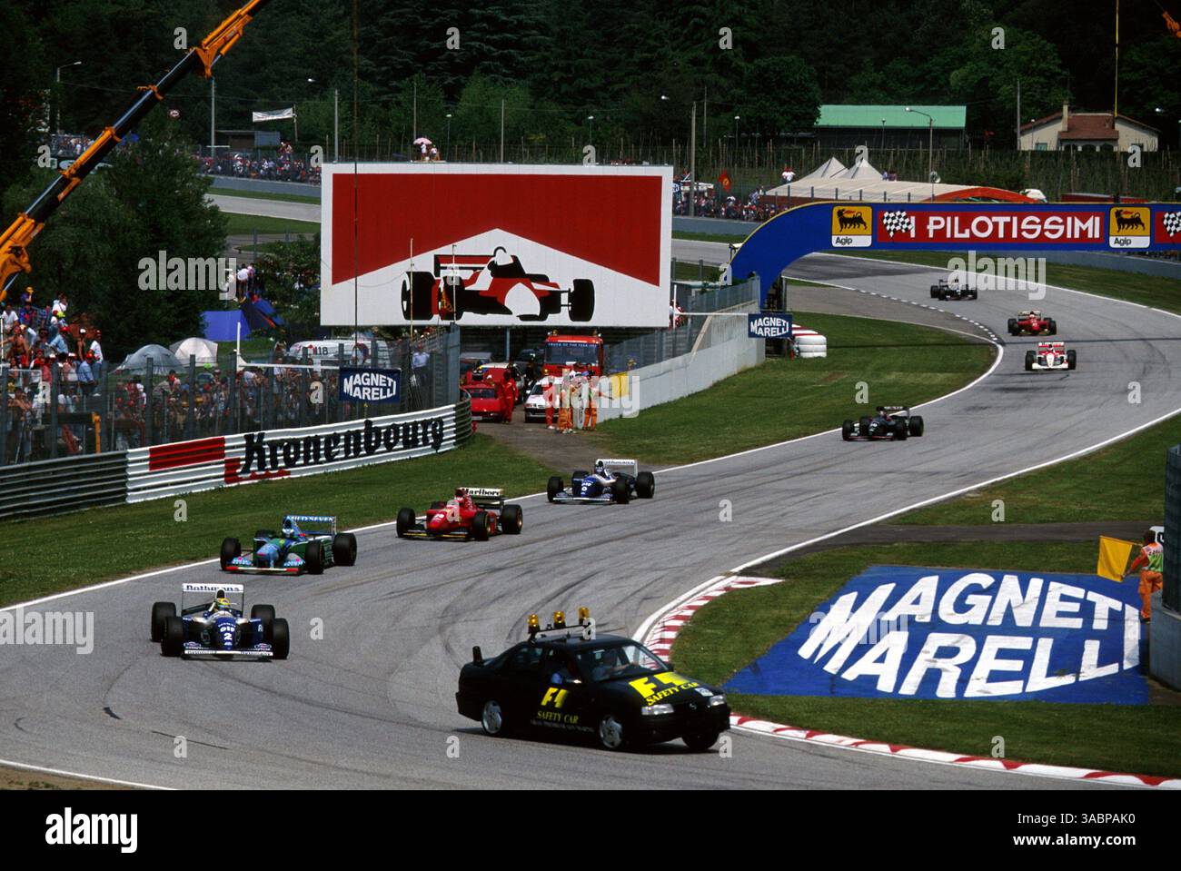 Ayrton Senna (BRA) Williams FW16 follows the painfully slow Safety Car following the start line ...