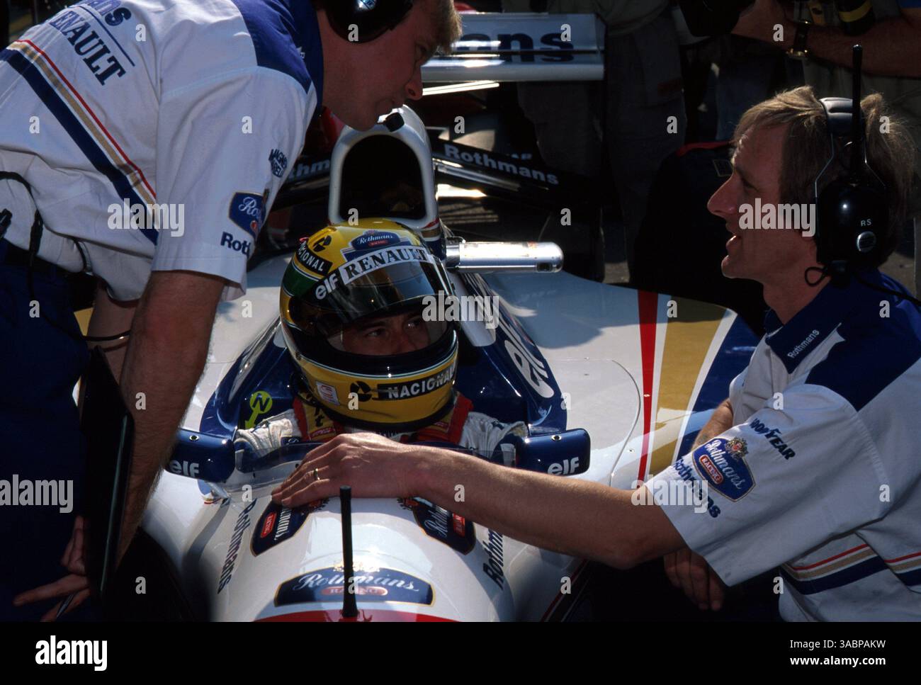 Ayrton Senna (BRA) Williams FW16 looks on as race engineer David Brown ...