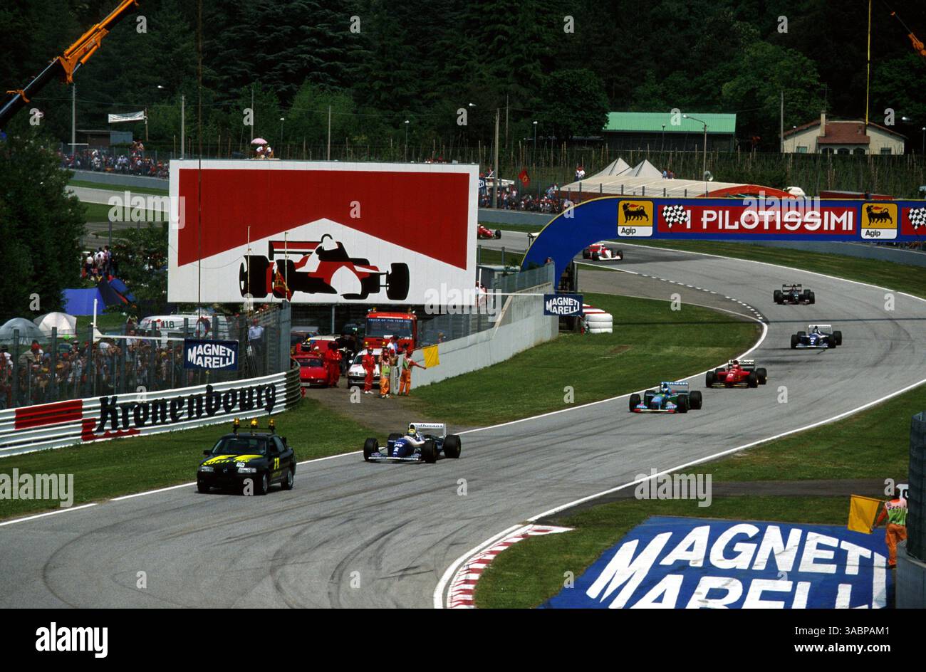 Ayrton Senna (BRA) Williams FW16 follows the painfully slow Safety Car following the start line ...