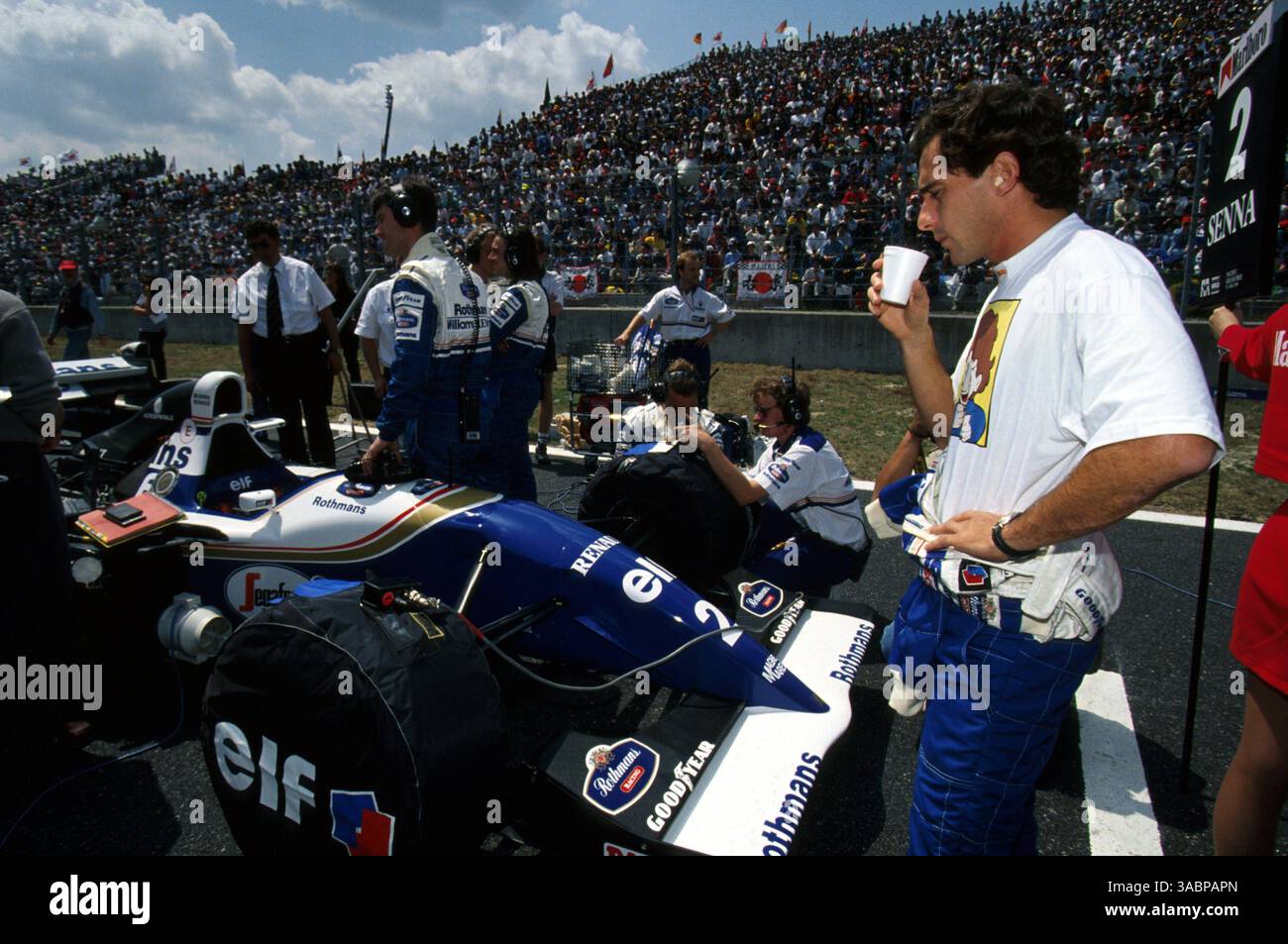 Pole sitter Ayrton Senna (BRA) watches his mechanics prepare the ...