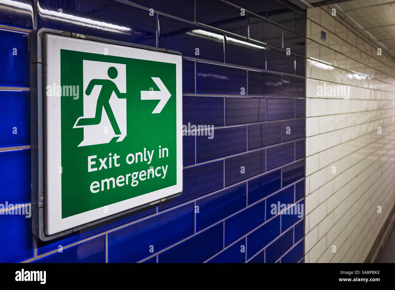 Emergency Exit Sign on Blue Tiled Wall in London Underground Station ...