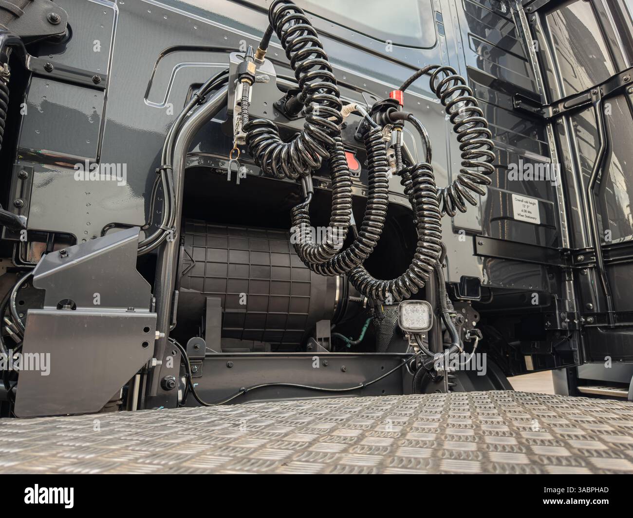 Close-up view of a fifth wheel coupling system and electric cables on a ...
