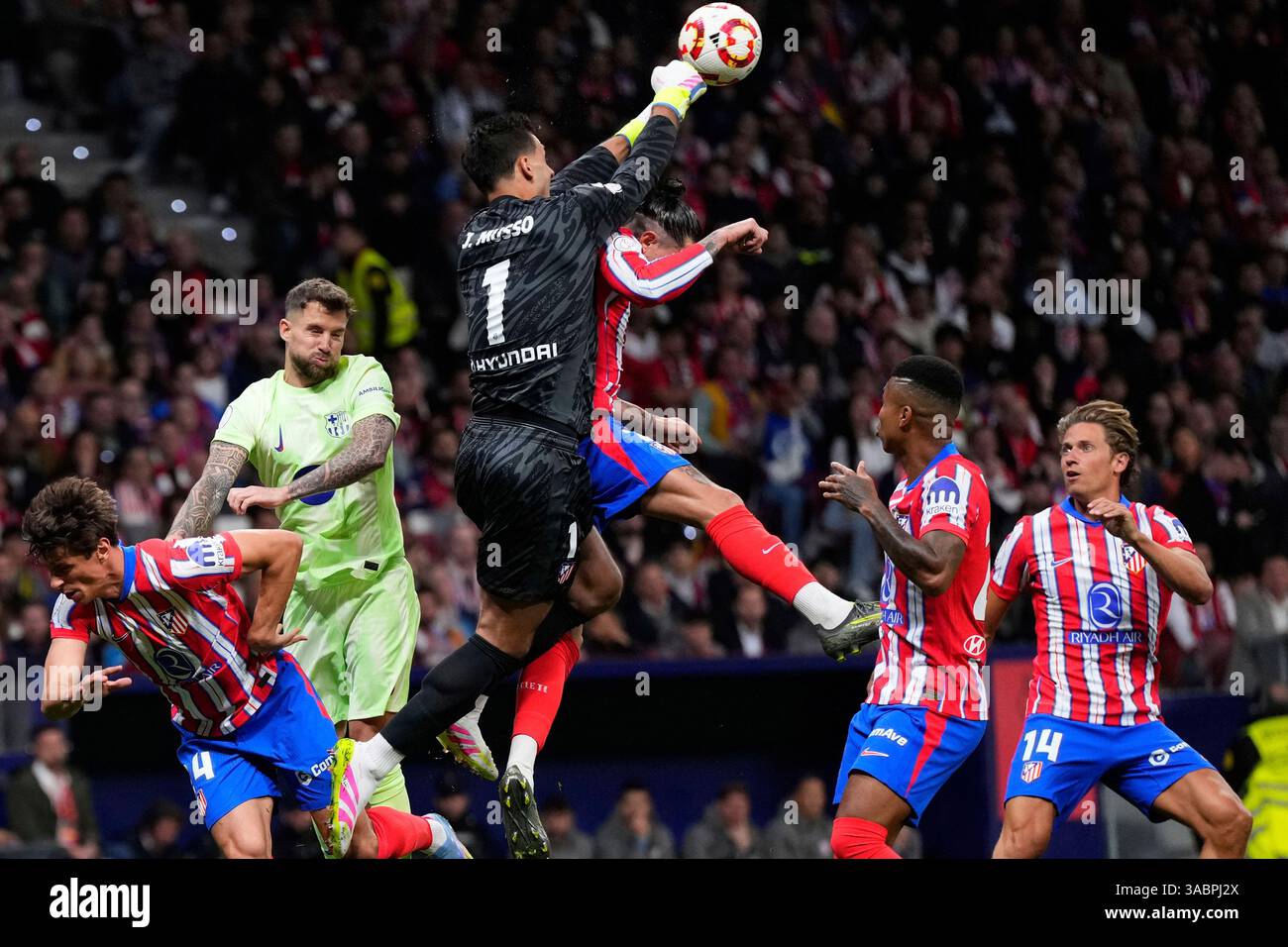 Atletico Madrid's goalkeeper Juan Musso punches out the ball during the ...
