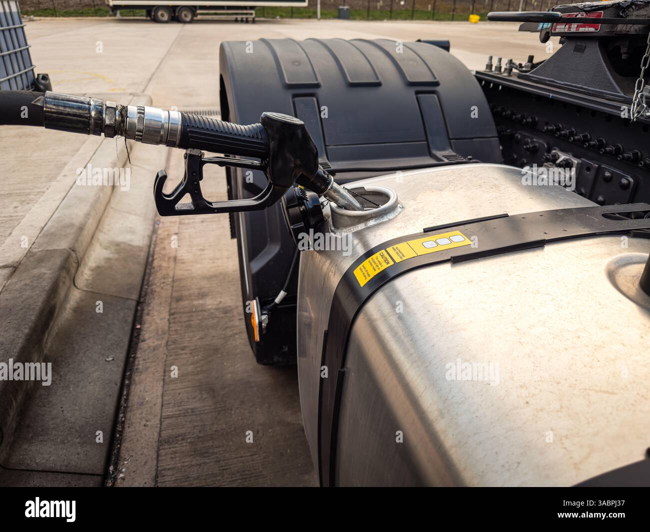 Lorry fill up with diesel. refuelling diesel to lorry tank, large hose ...