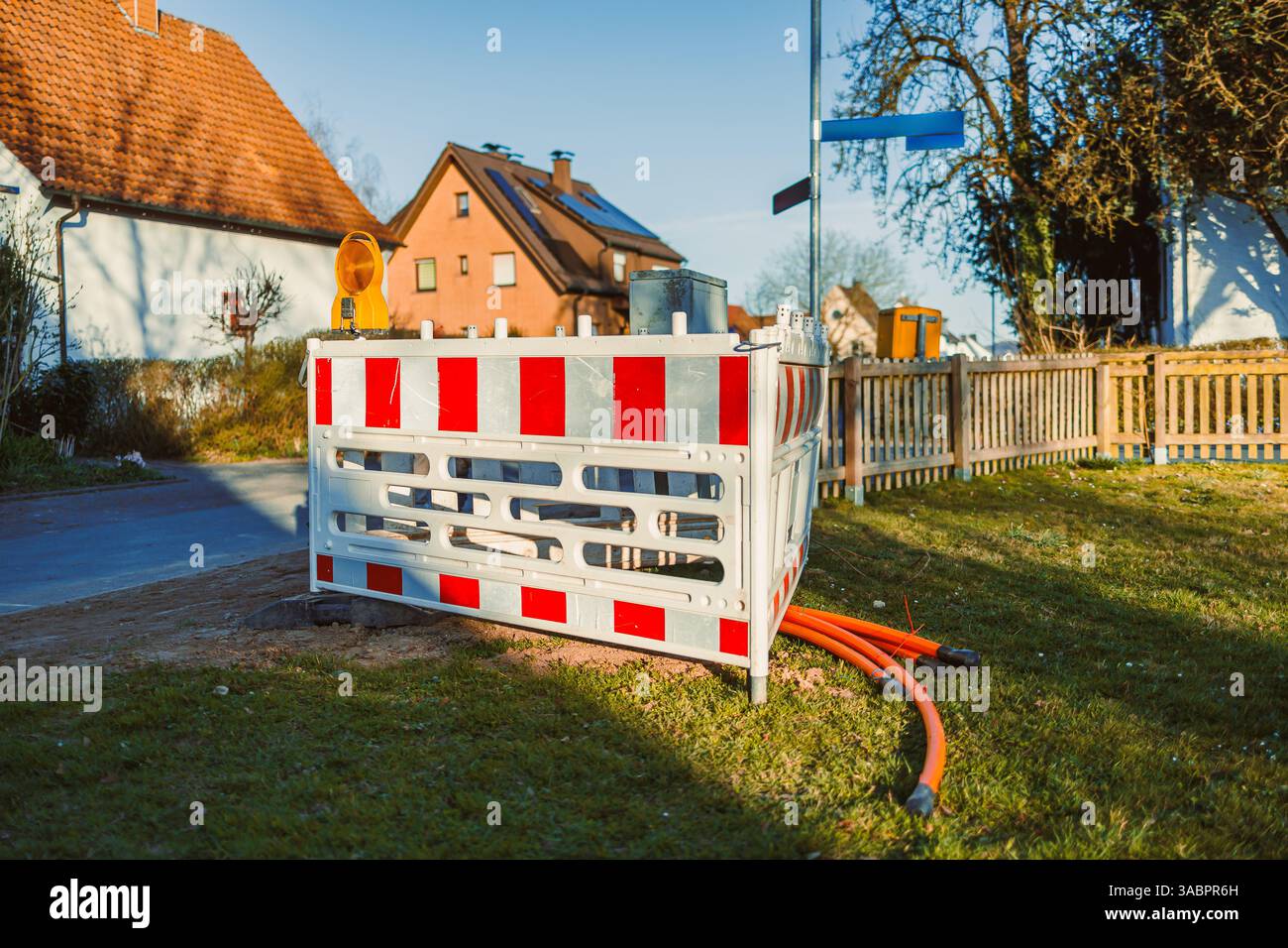 In the neighborhood, a striking red and white construction barrier ...