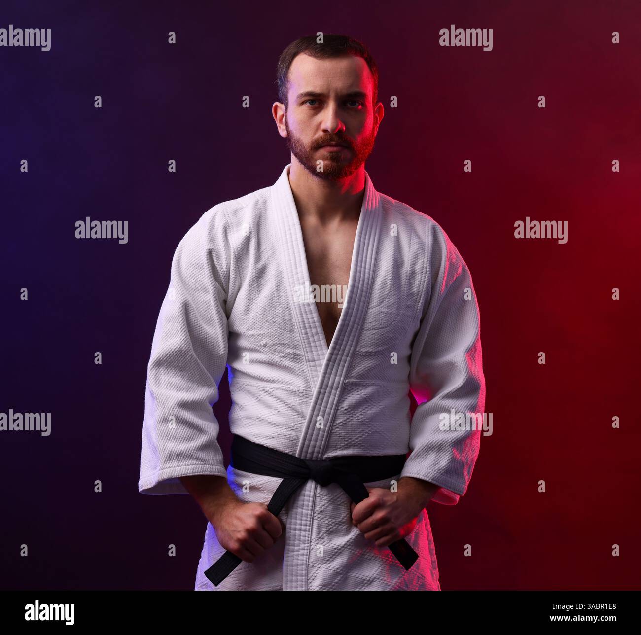 Karate fighter wearing uniform in color lights Stock Photo - Alamy