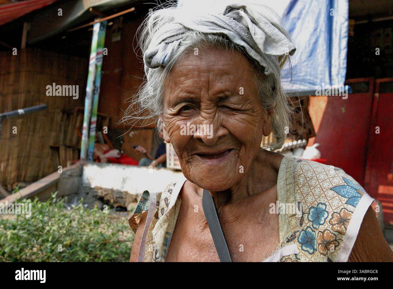 Apr 23, 2004 - Manila, PHILIPPINES - An elderly woman leaves a street ...