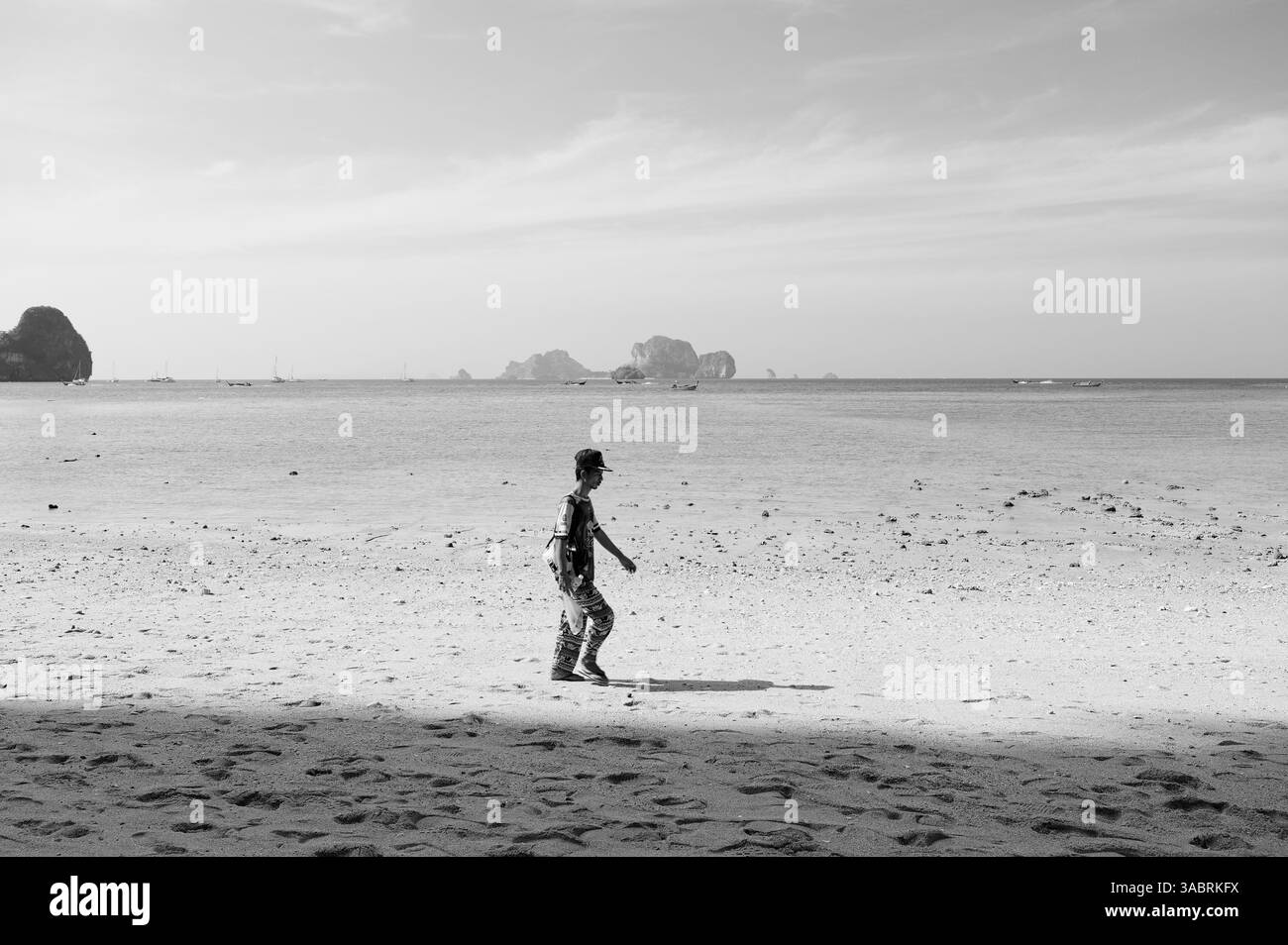 Man walks barefoot along seashore hi-res stock photography and images ...