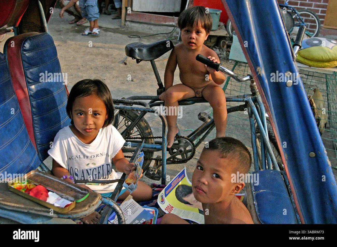 Apr 19, 2004 - Manila, PHILIPPINES - Children play in a peddle taxi in ...