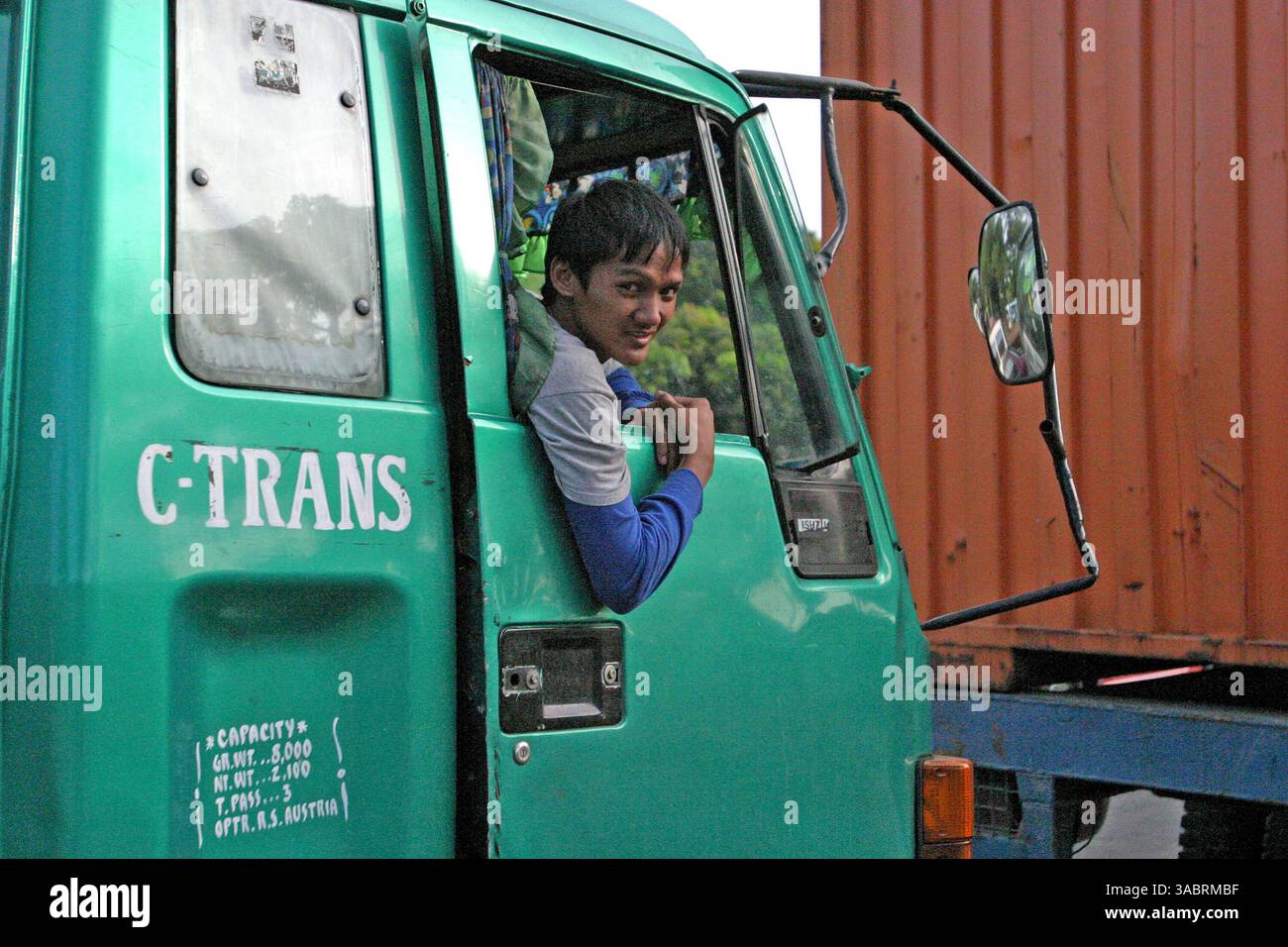 Apr 29, 2004 - Manila, PHILIPPINES - A truck driver leans out of the ...