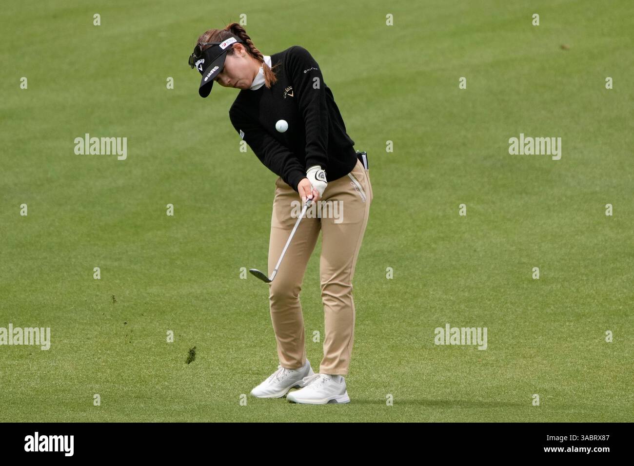 Yuna Nishimura chips on the fourth fairway during the first round of ...