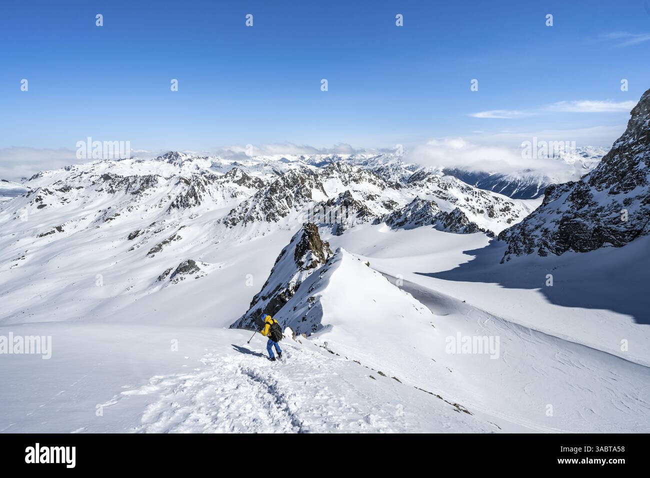Mountaineer with ice axe and crampons, ascent through steep snowfield ...