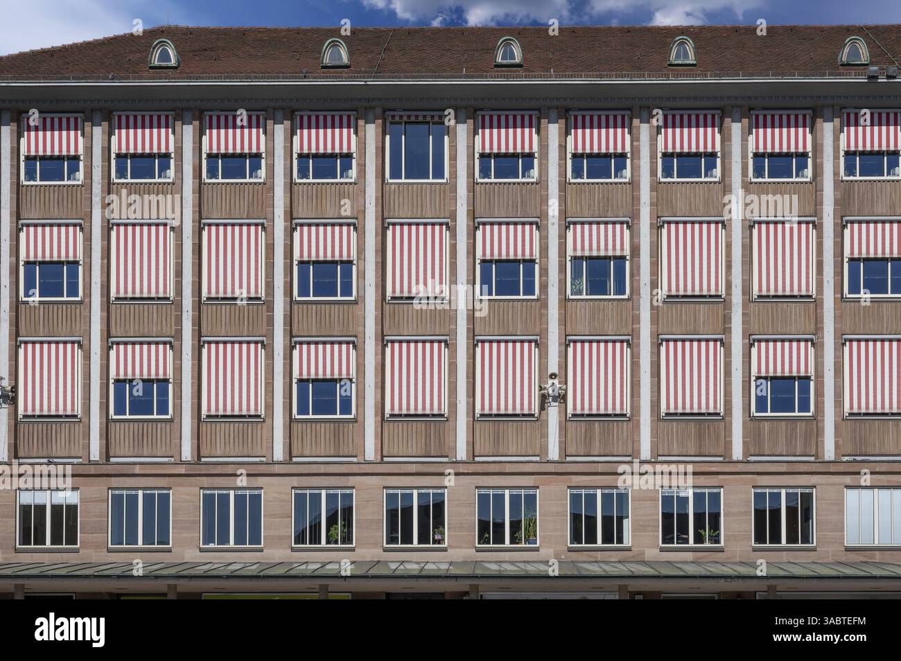 1950s facade of the New Town Hall with lowered red and white blinds on ...