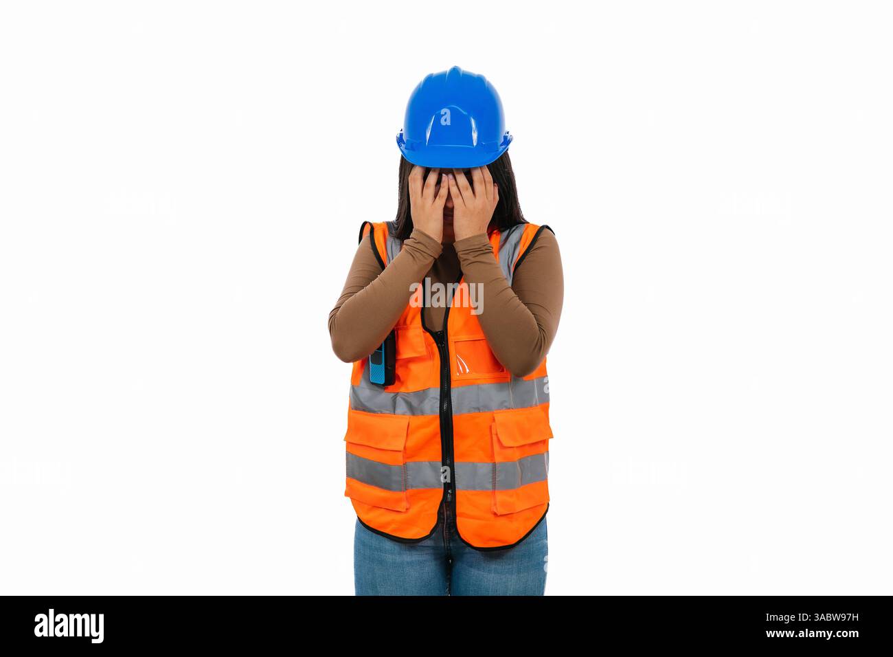 Young stressed Latina construction worker wearing safety vest and ...