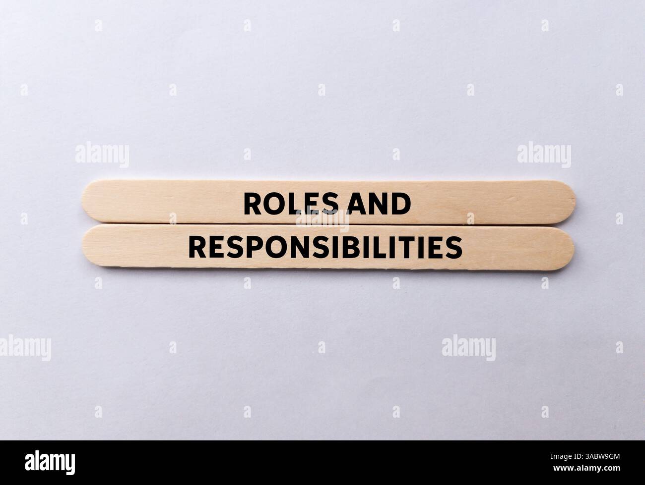 Roles and responsibilities message written on wooden sticks on white ...