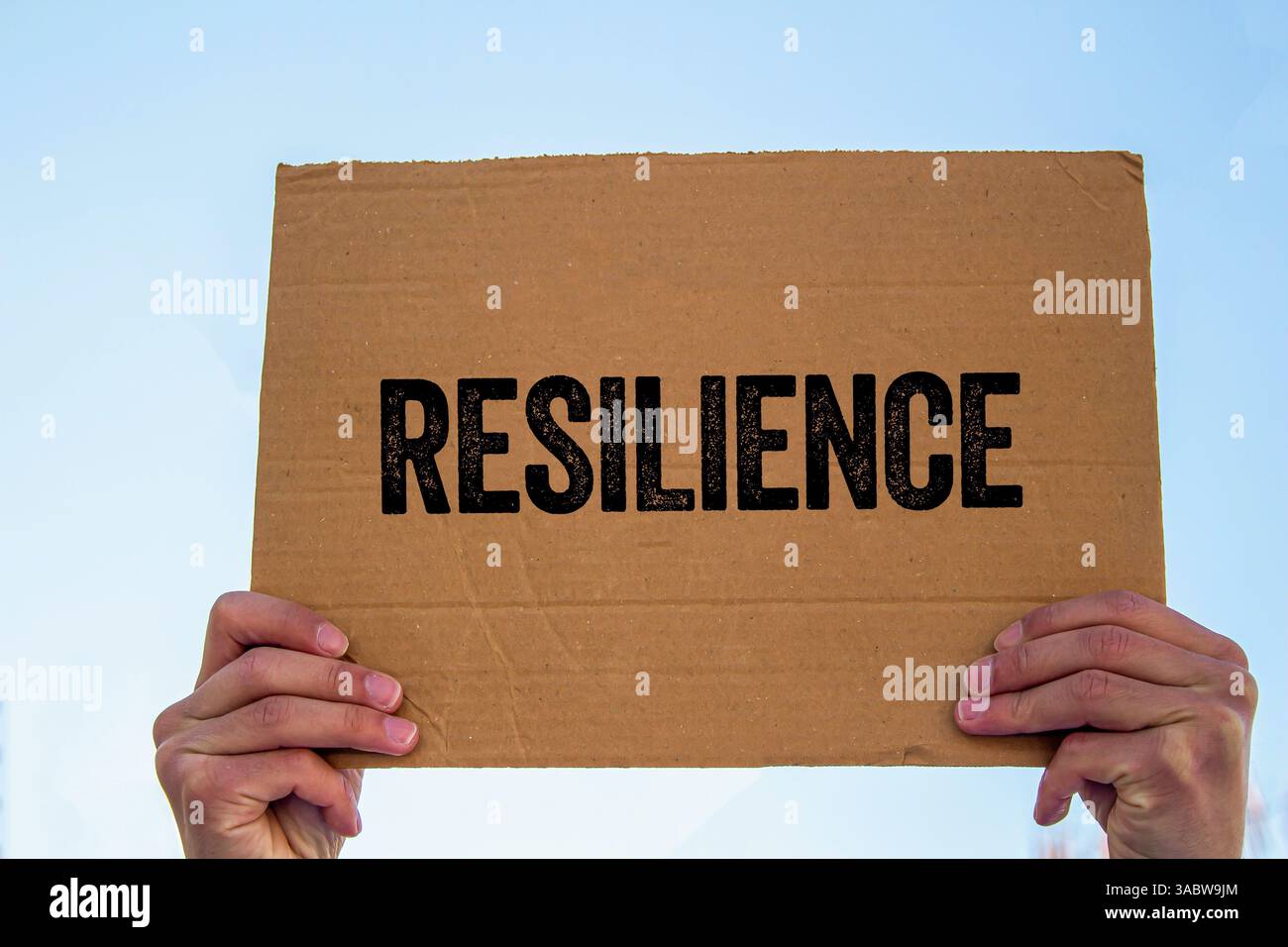 Resilience message written on cardboard sign. Conceptual resilience ...