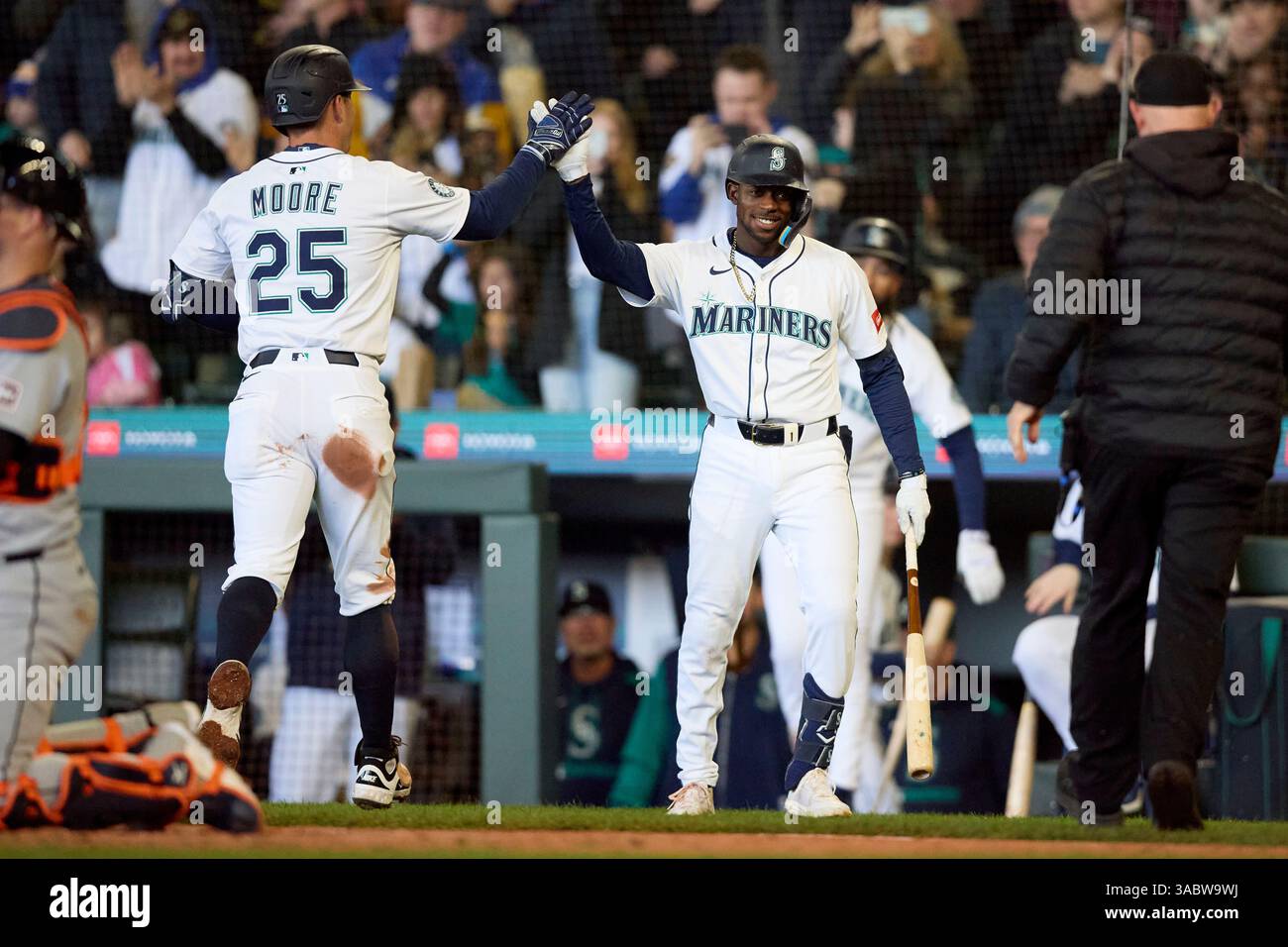 Seattle Mariners' Dylan Moore is greeted at home by Ryan Bliss his solo ...