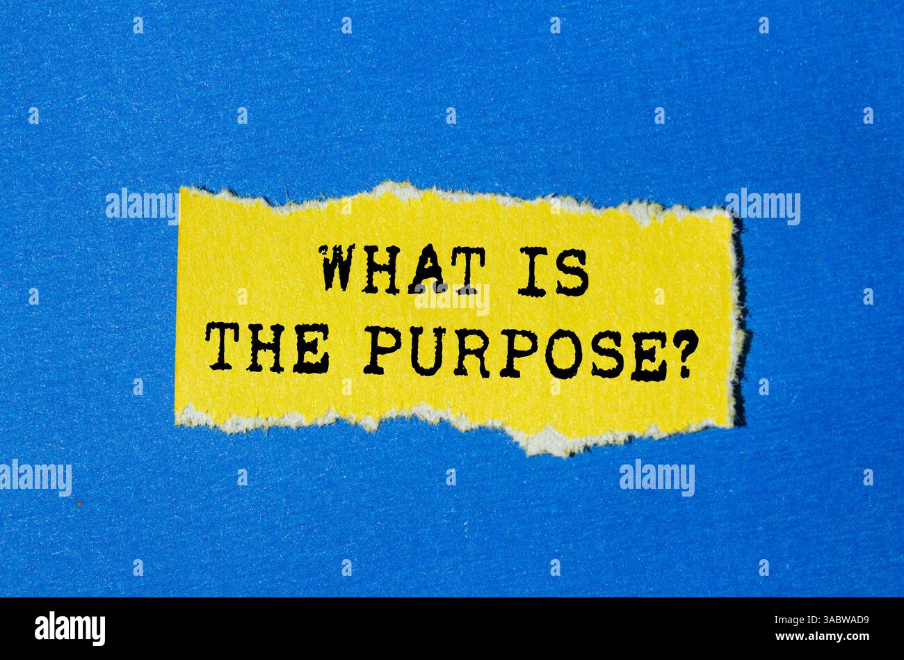 What is the purpose message written on ripped torn yellow paper on blue ...