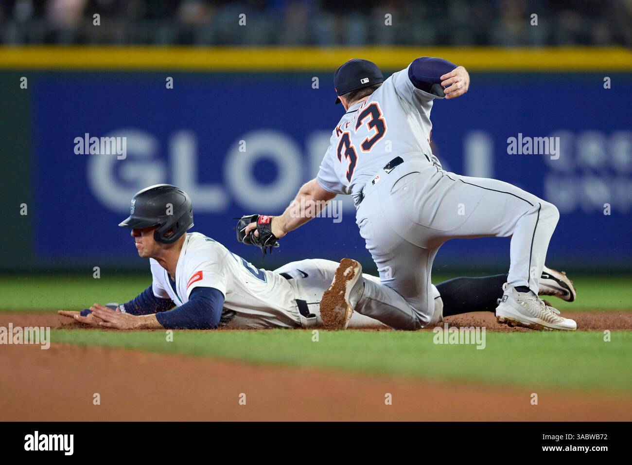 Seattle Mariners' Dylan Moore slides under the tag from Detroit Tigers ...