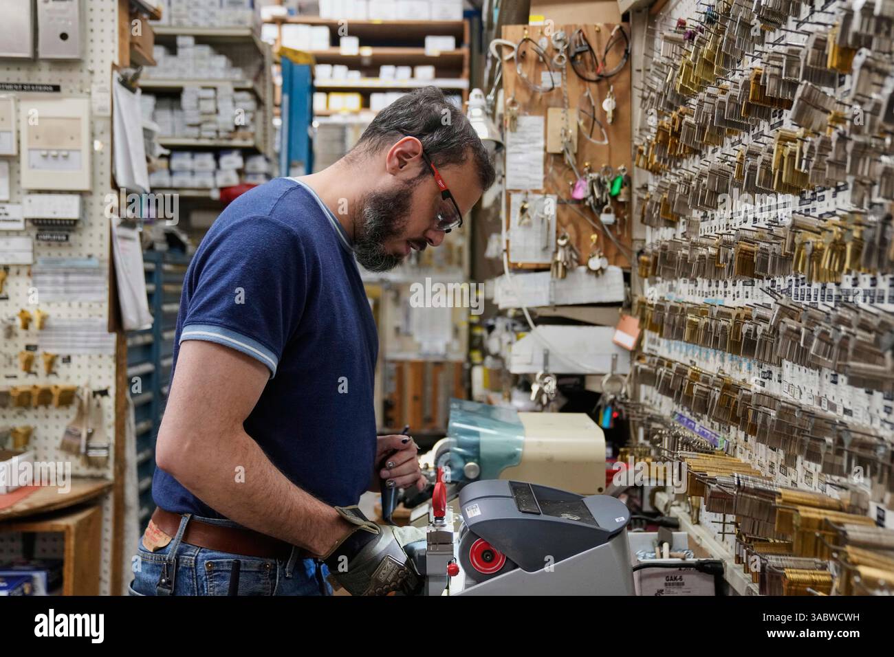 Employee Jon Vazquez-DeAnda cuts keys for a customer at employee-owned ...