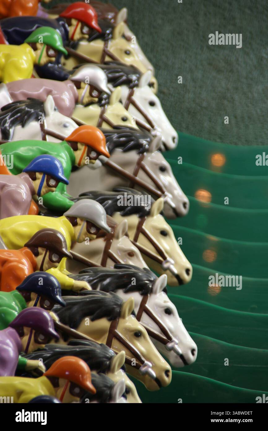 Jockeys prepare to race their horses at a carnival midway game Stock ...