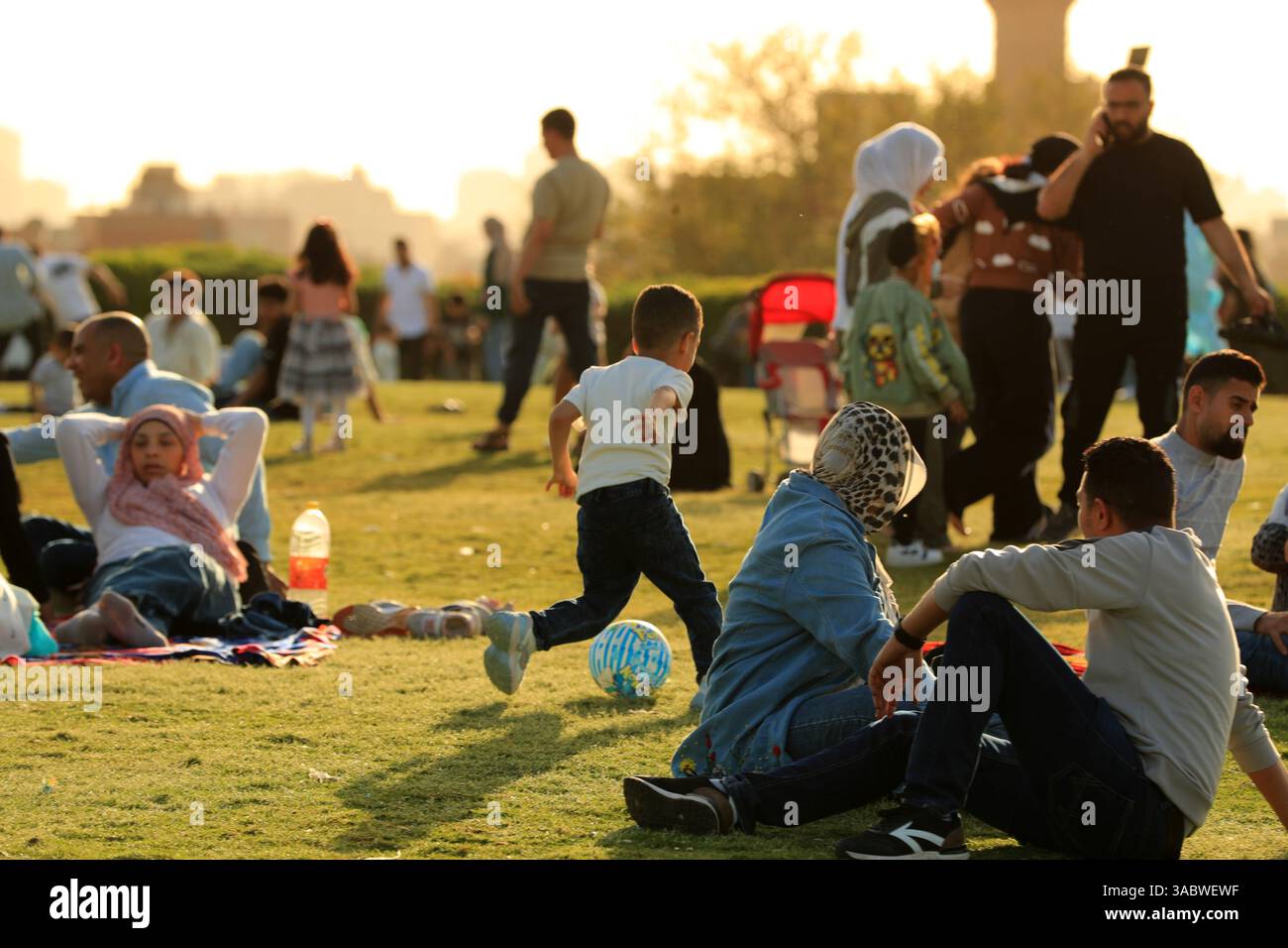 Cairo, Egypt. 2nd Apr, 2025. A boy plays a ball at Al-Azhar Park in ...